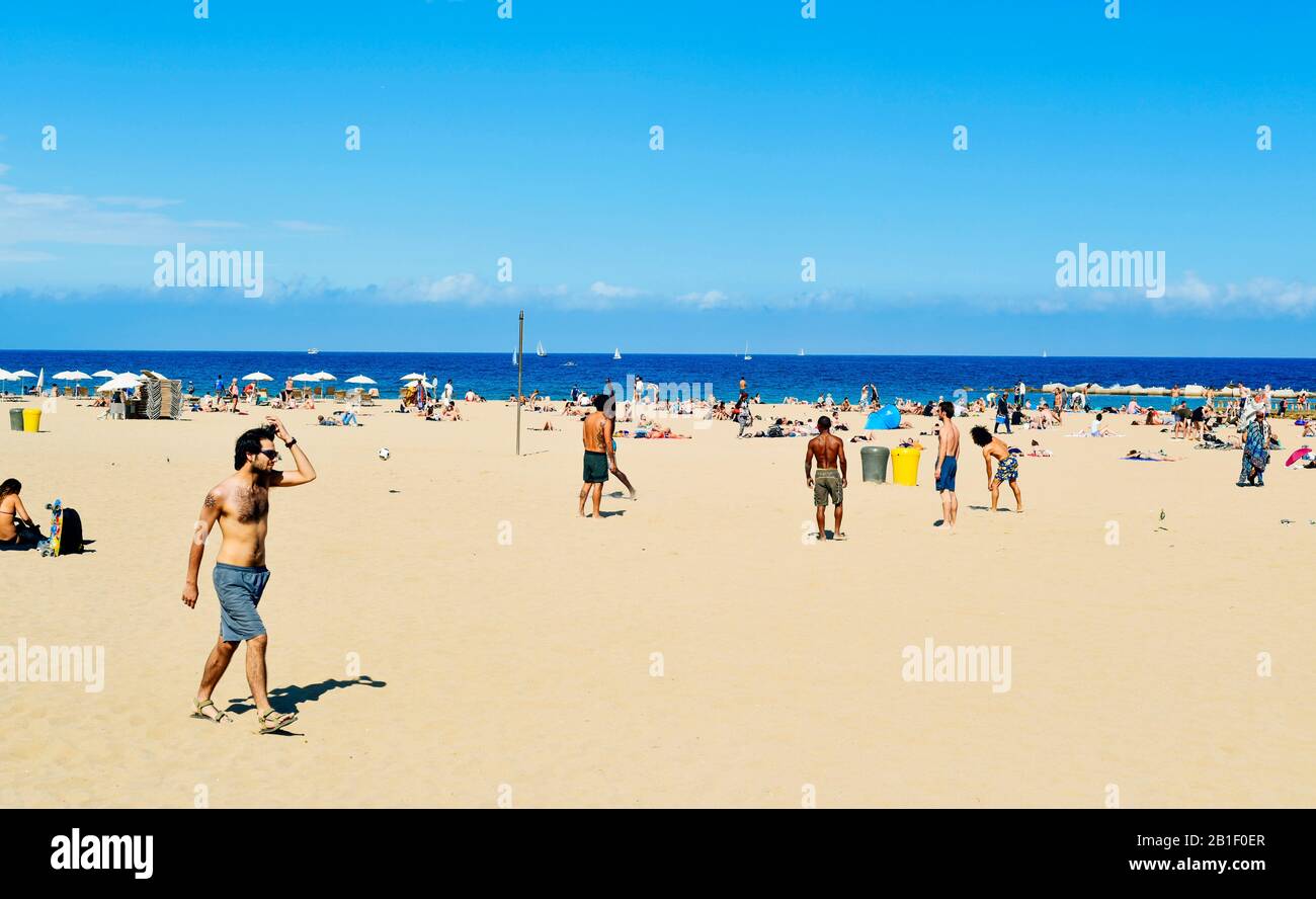 BARCELONA, SPAIN - MAY 30: People playing beach football and sunbathing ...
