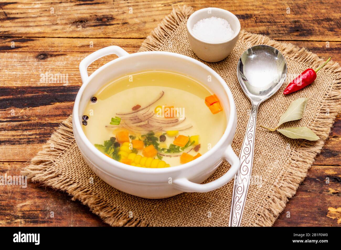 Transparent duck broth in bowl with vegetables. Traditional bouillon ...