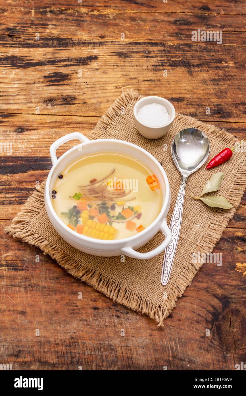 Transparent duck broth in bowl with vegetables. Traditional bouillon ...