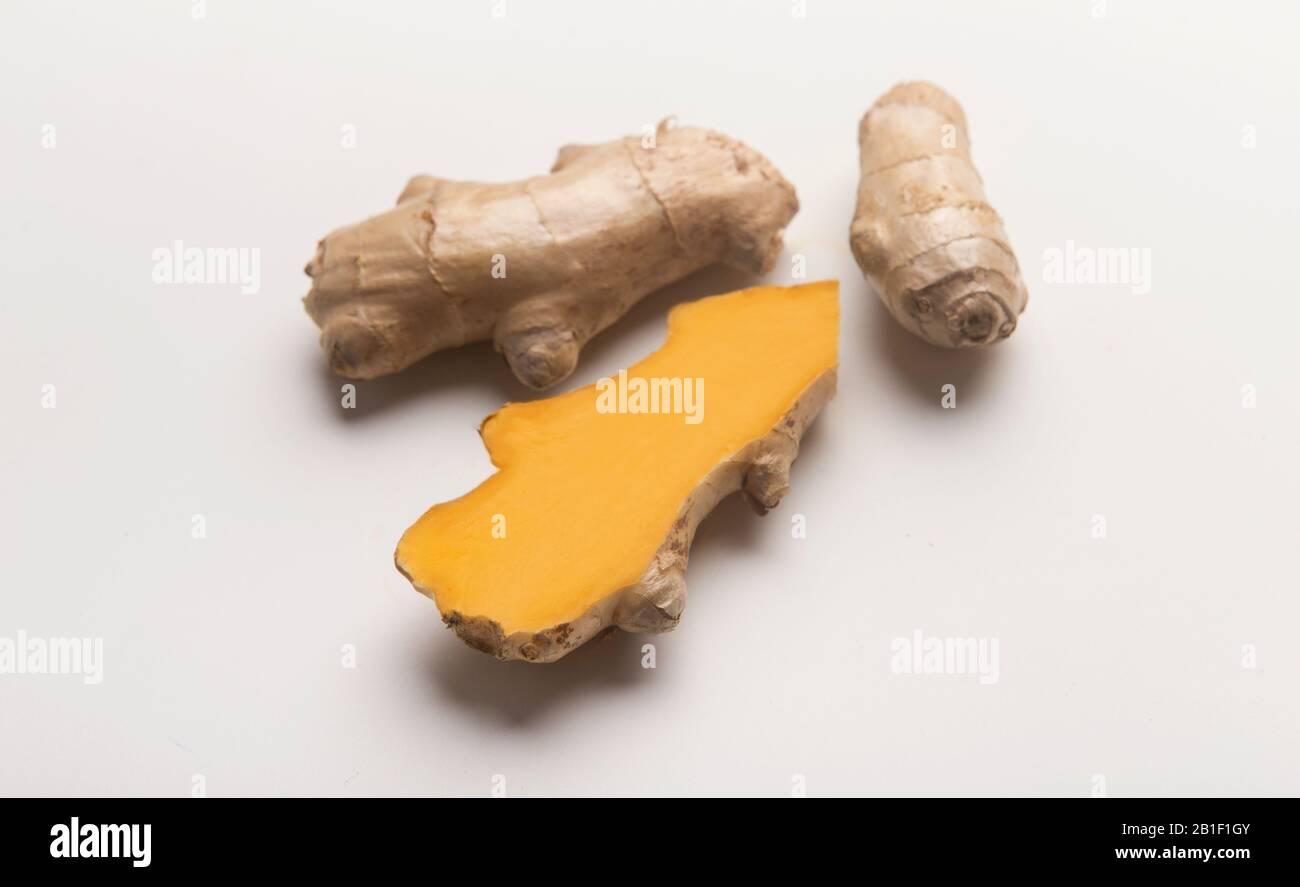 Yellow fresh Turmeric root or Curcuma longa on white Stock Photo - Alamy