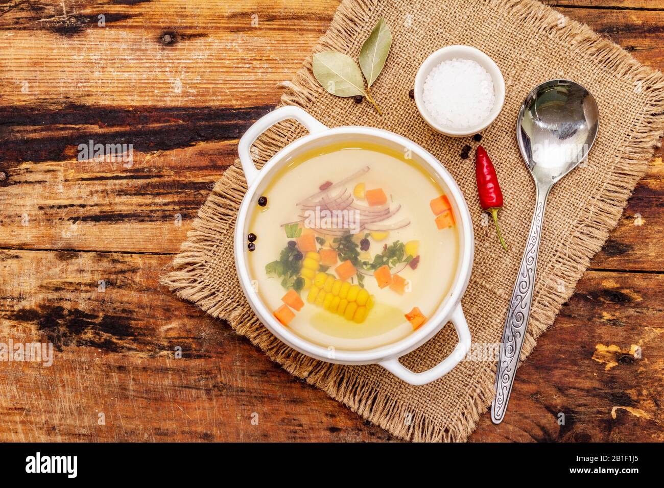 Transparent duck broth in bowl with vegetables. Traditional bouillon ...