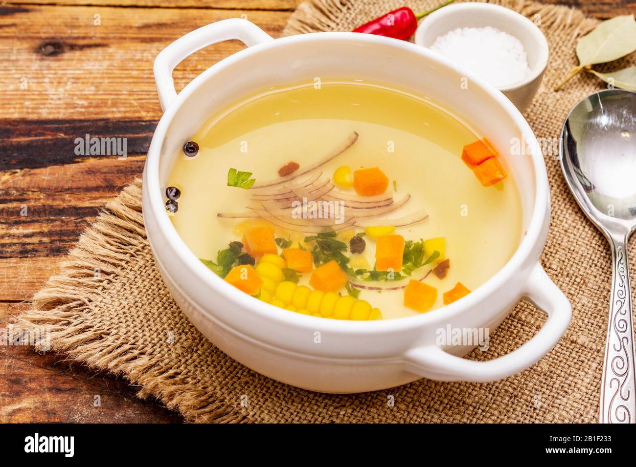 Transparent duck broth in bowl with vegetables. Traditional bouillon ...