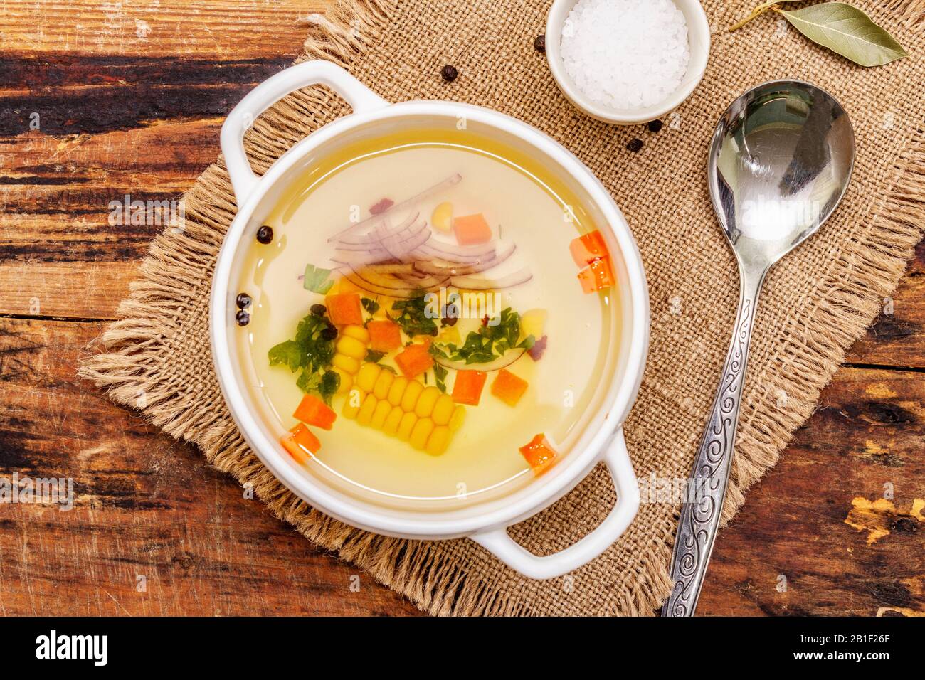 Transparent duck broth in bowl with vegetables. Traditional bouillon ...