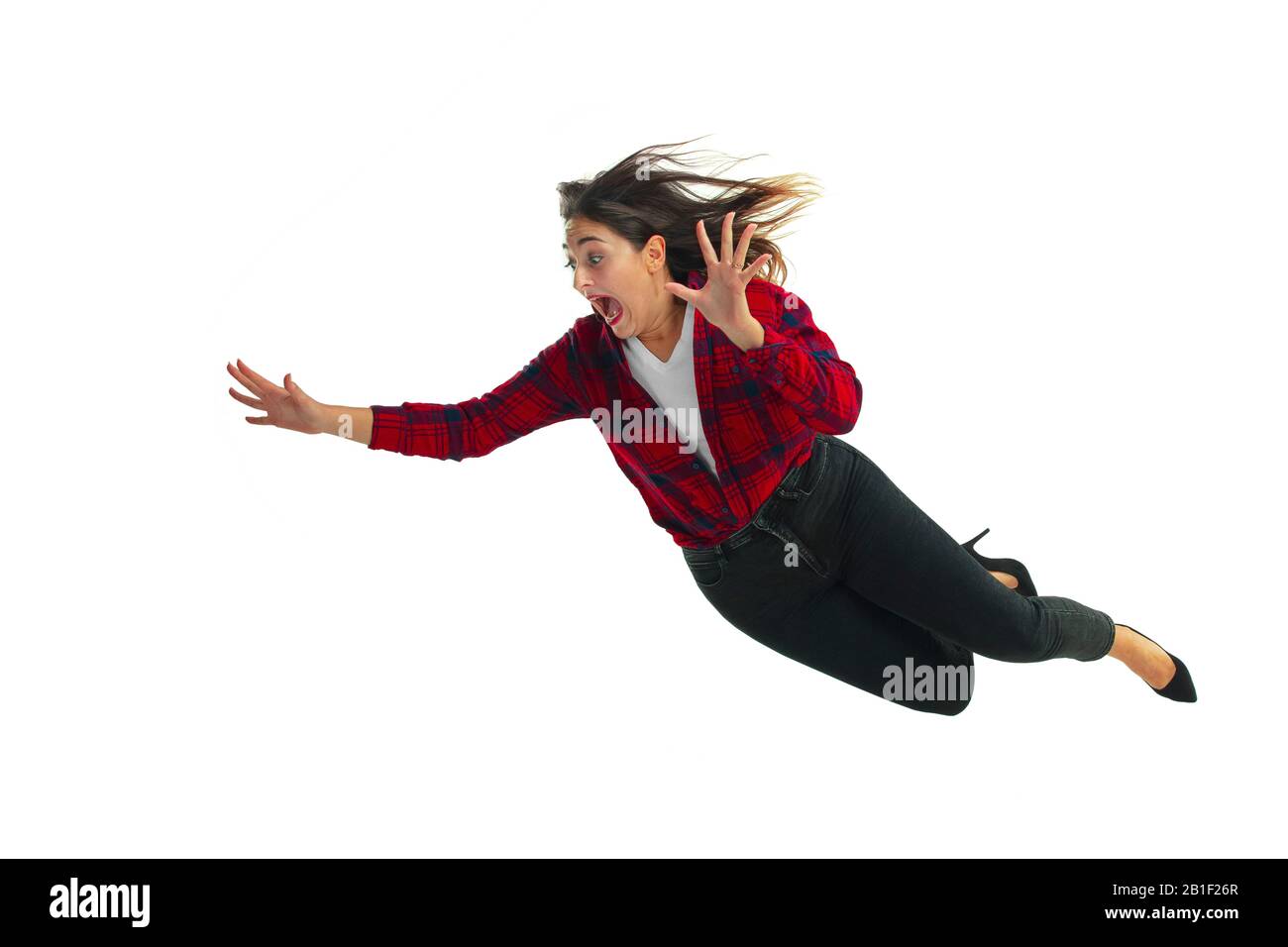 A second before falling. Caucasian young girl falling down in moment ...