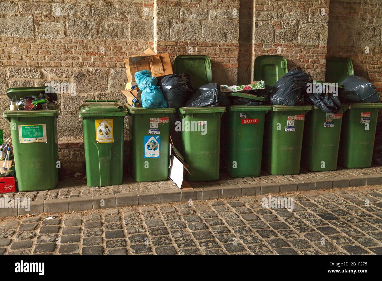 Green plastic garbage containers filled with trash on top Stock Photo ...