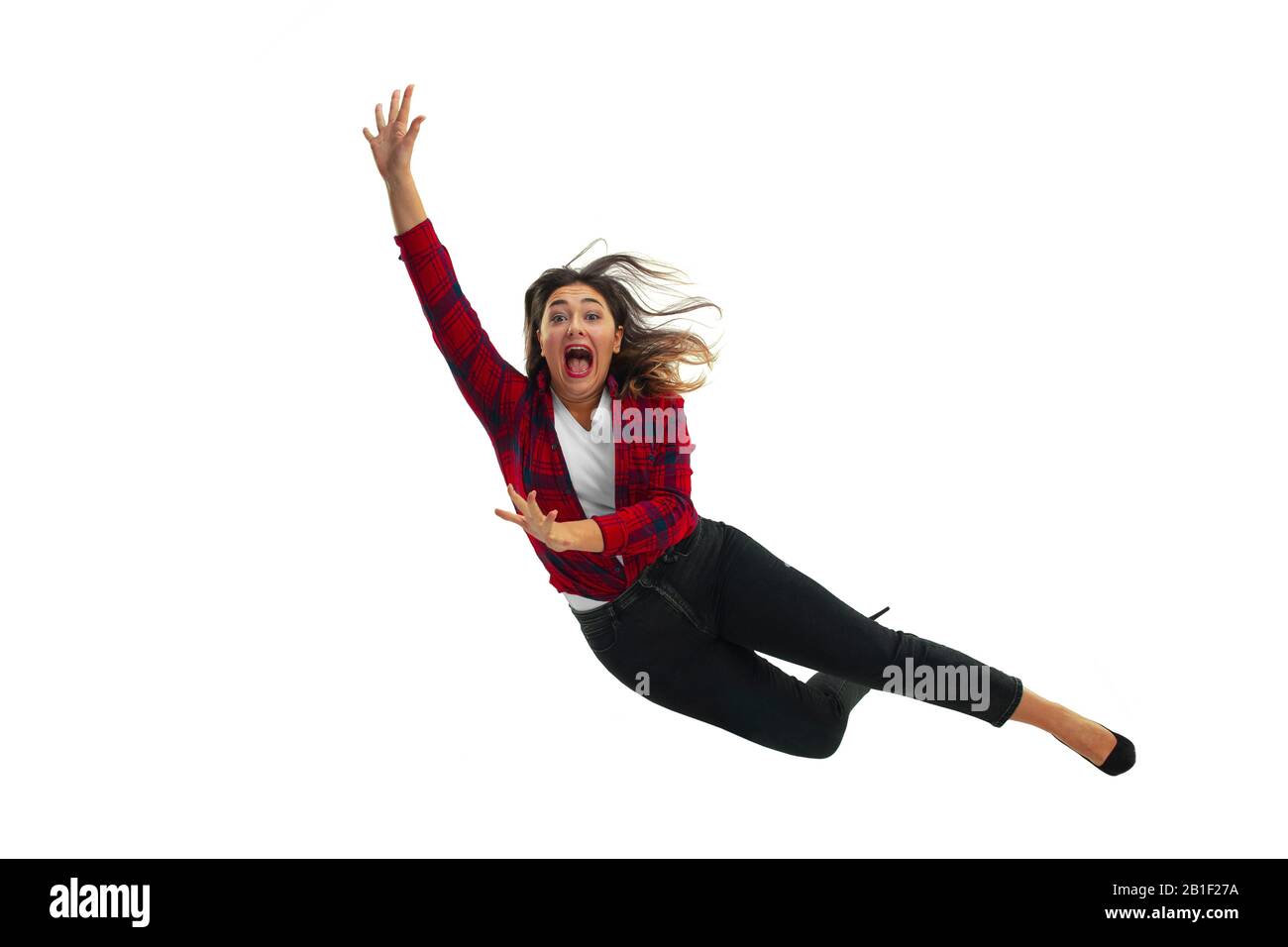 A second before falling. Caucasian young girl falling down in moment ...