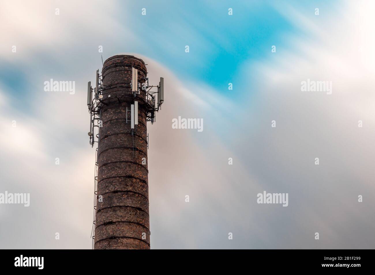 Industrial smoke from chimney on windy sky. Long exposure Stock Photo ...