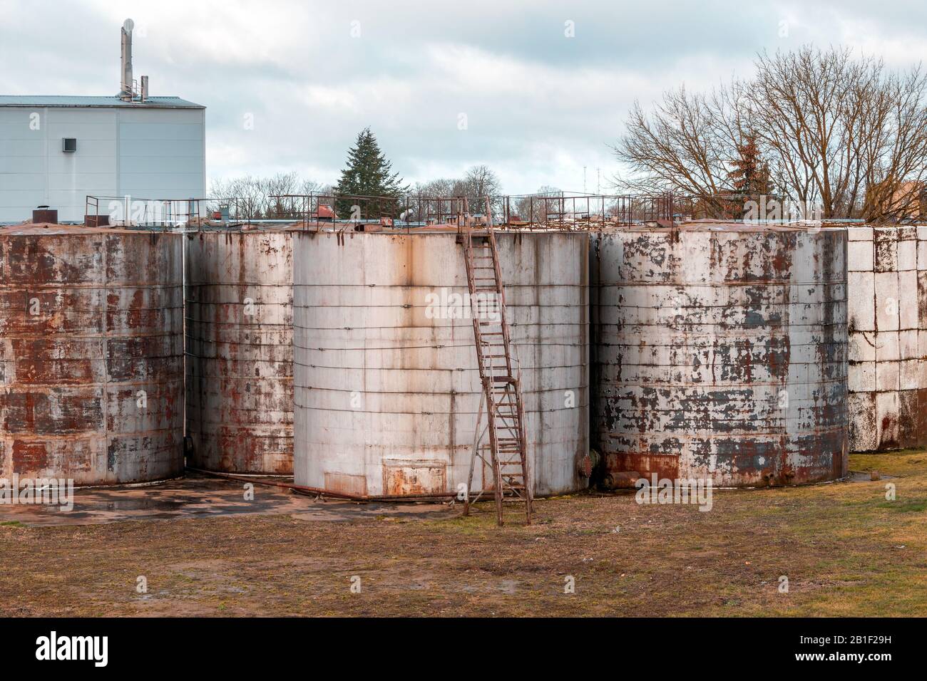 Old oil tanks in abandoned cargo service terminal Stock Photo - Alamy