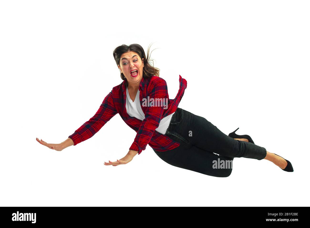 A second before falling. Caucasian young girl falling down in moment ...