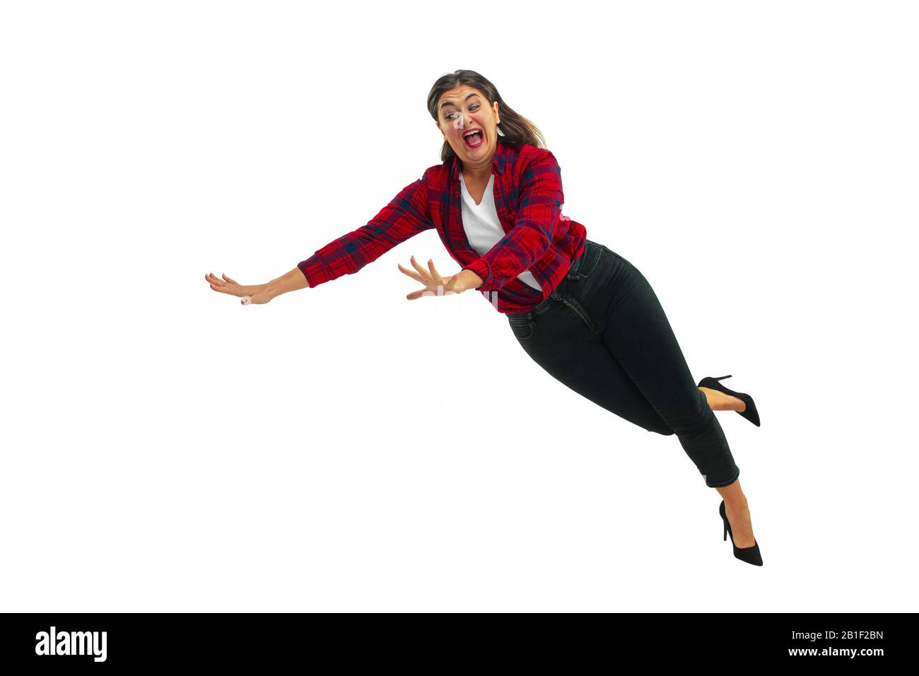A second before falling. Caucasian young girl falling down in moment ...