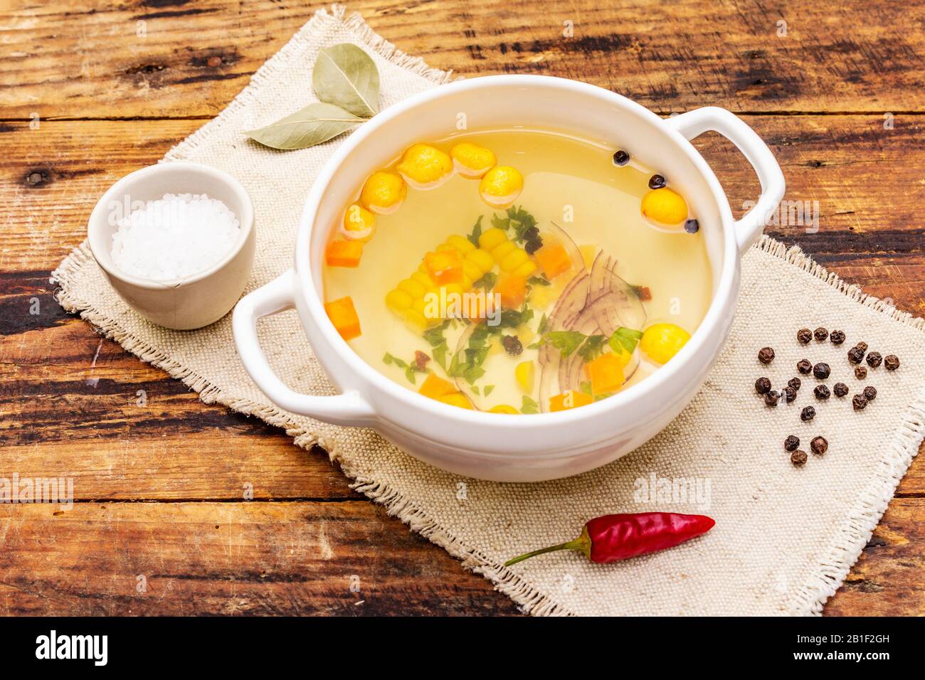 Transparent duck broth with dumplings and vegetables. Traditional ...
