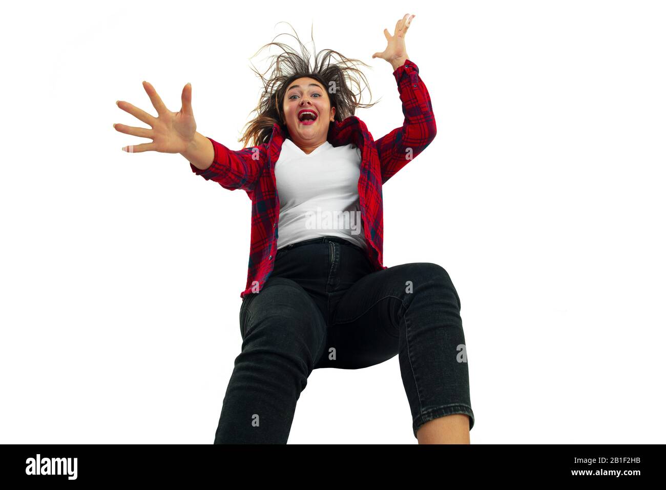 A second before falling. Caucasian young girl falling down in moment ...