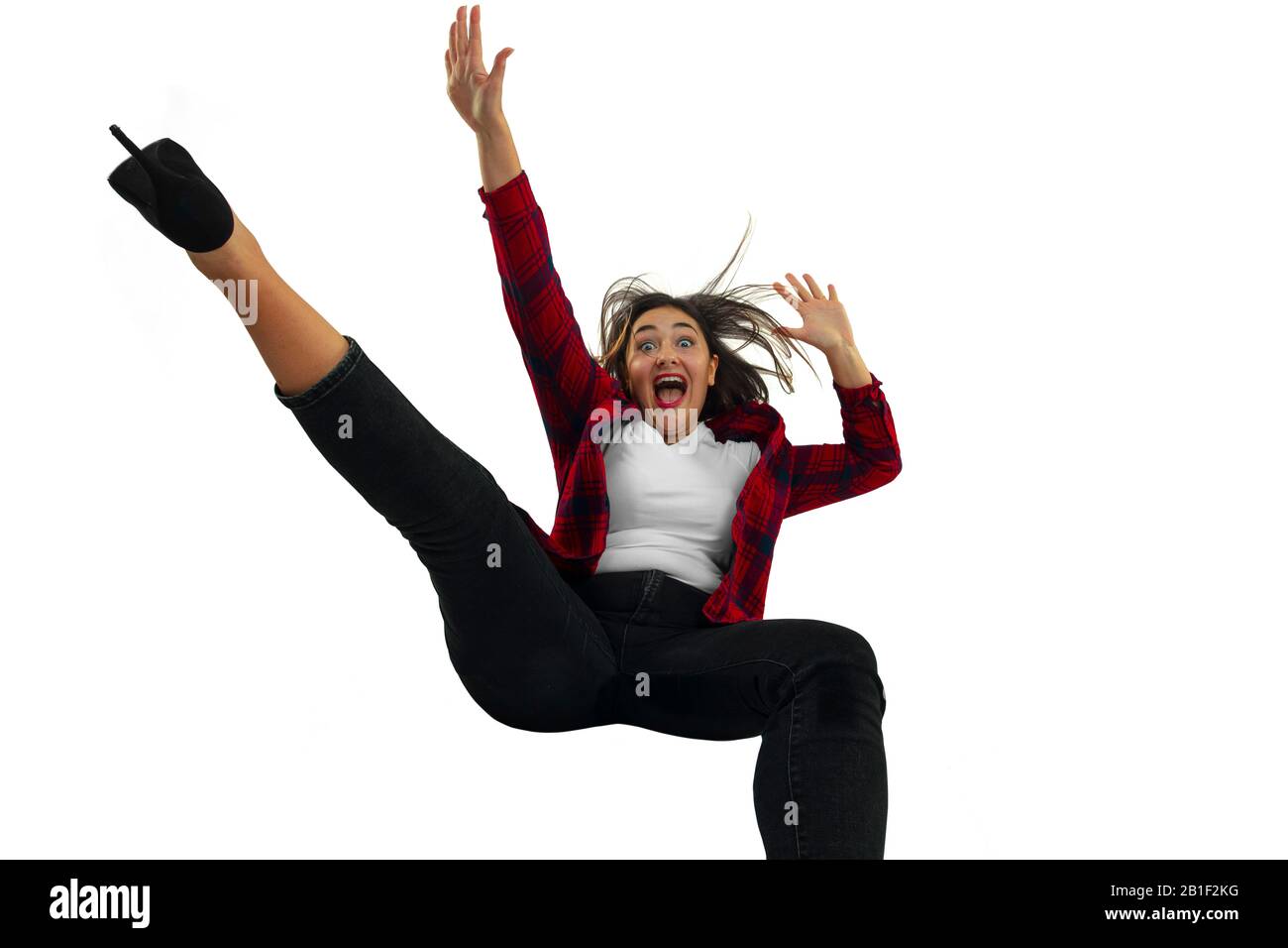 A second before falling. Caucasian young girl falling down in moment ...