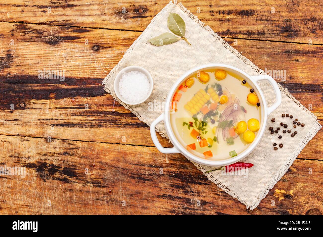 Transparent duck broth with dumplings and vegetables. Traditional ...