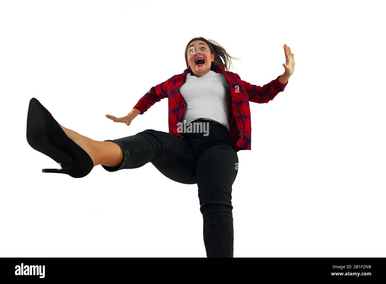 A second before falling. Caucasian young girl falling down in moment ...