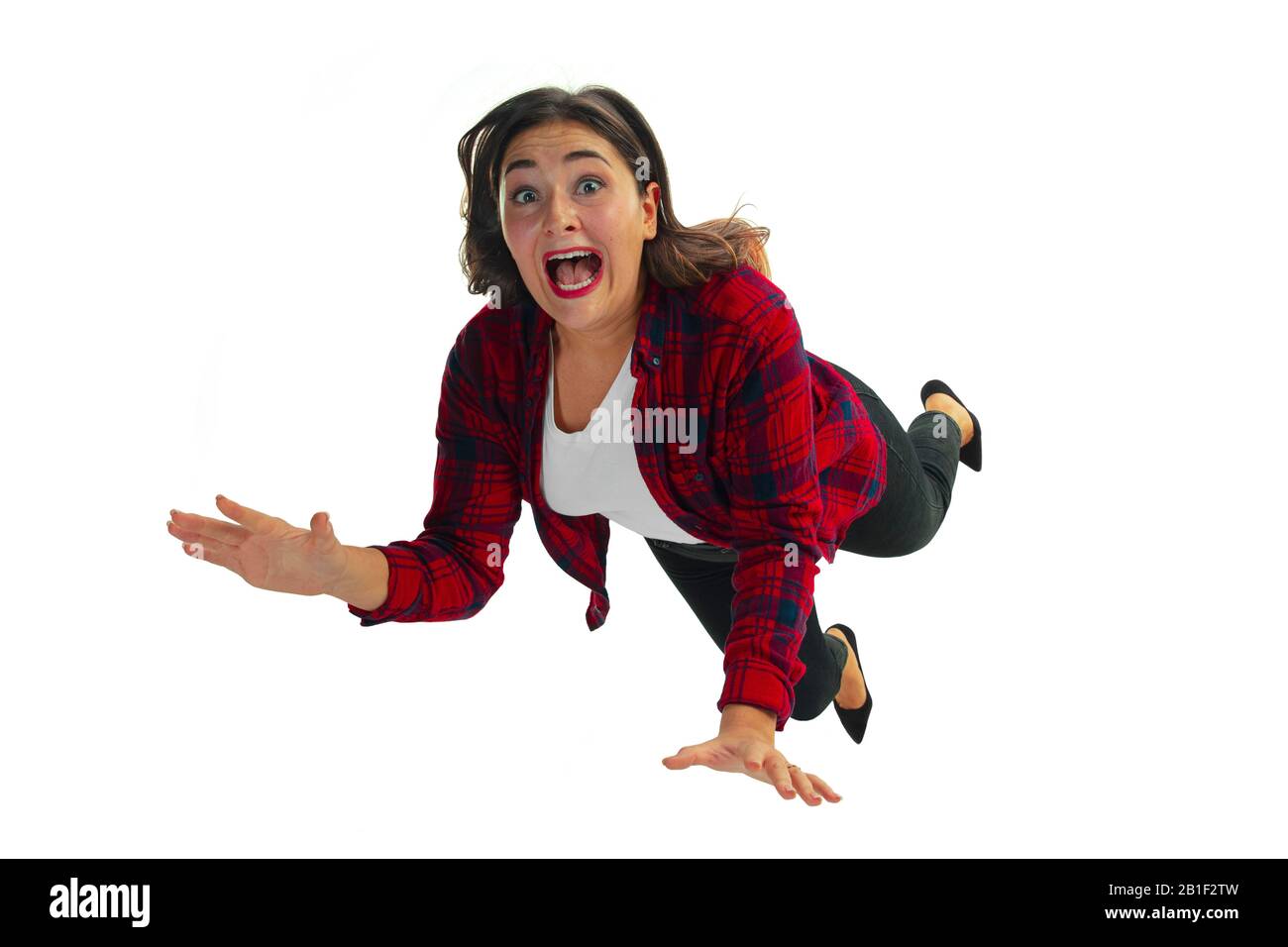 A second before falling. Caucasian young girl falling down in moment ...