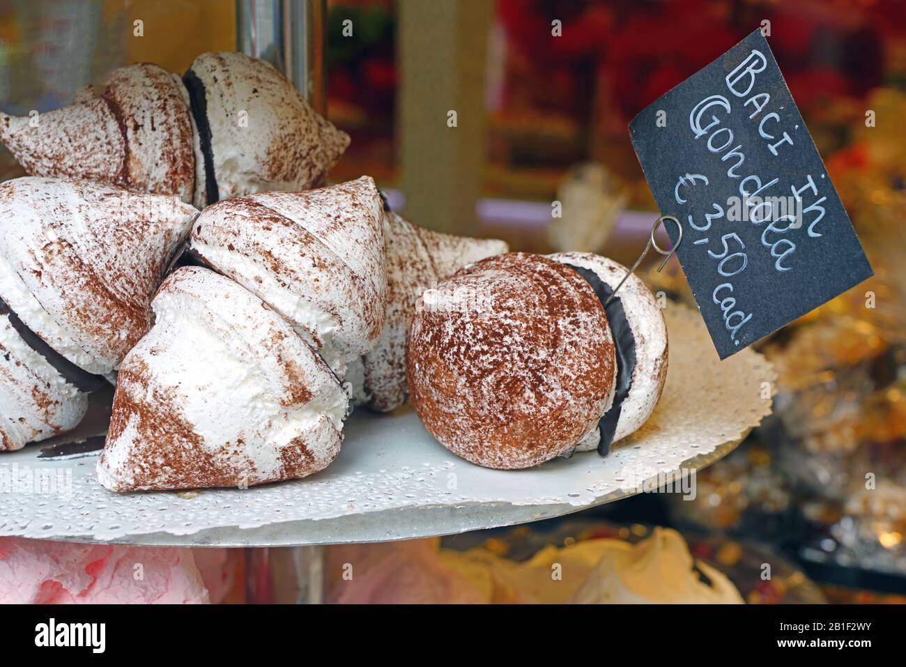 Italian baci in gondola meringue and chocolate cookies in a pastry shop ...