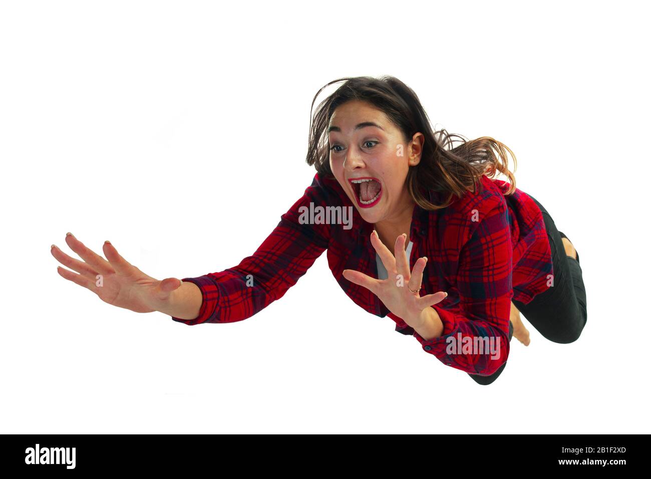 A second before falling. Caucasian young girl falling down in moment ...