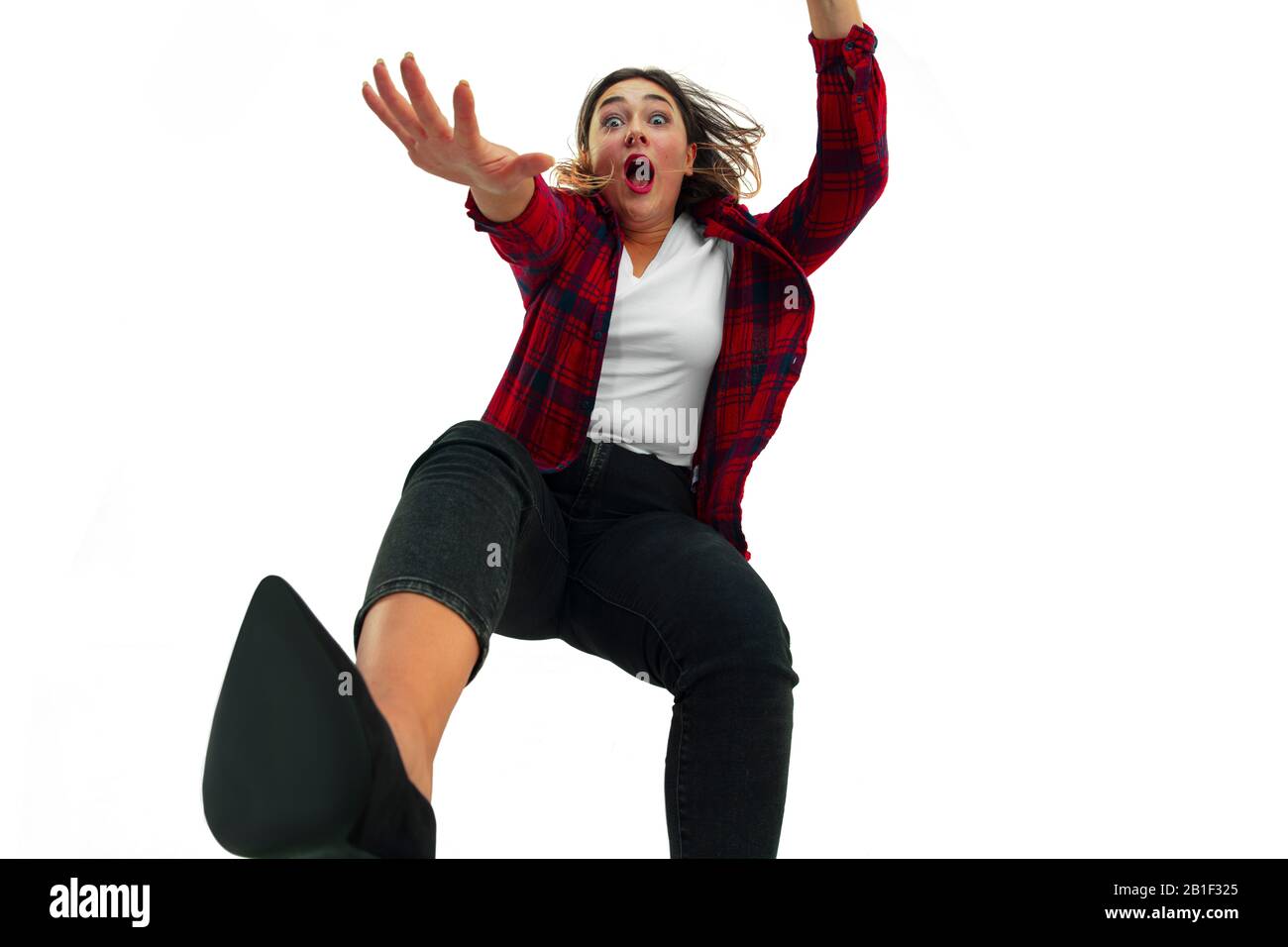 A second before falling. Caucasian young girl falling down in moment ...