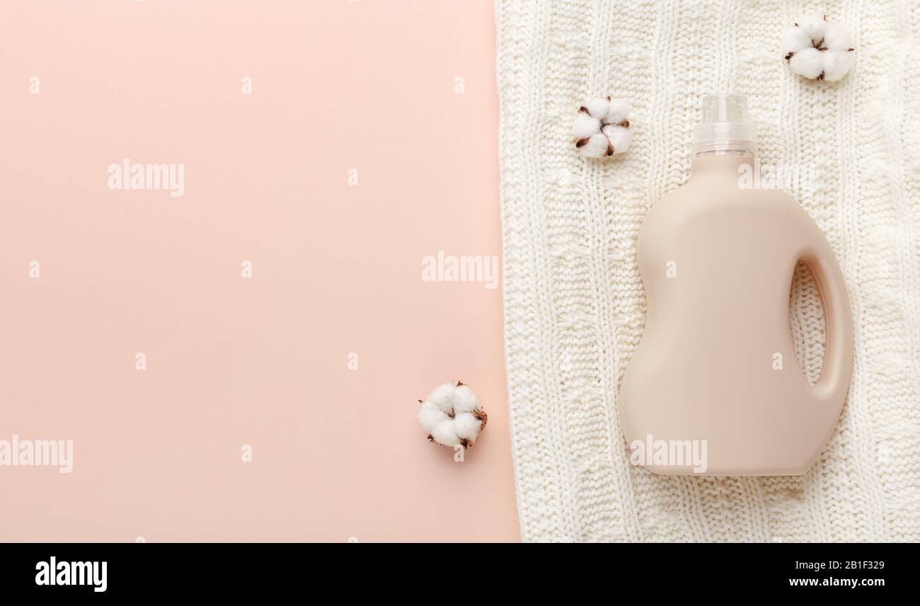 Plastic packaging with washing conditioner, towels and cotton flowers ...