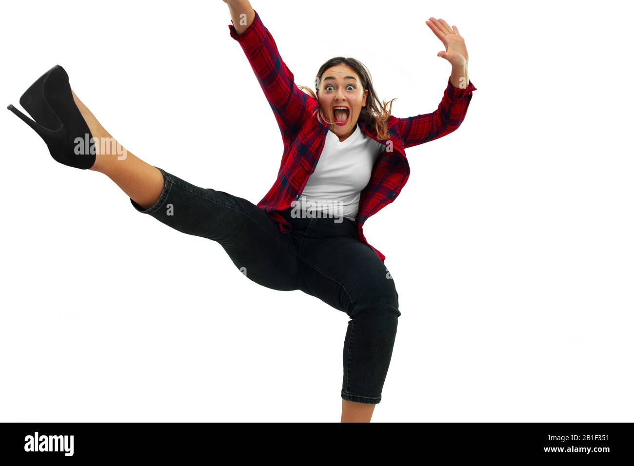 A second before falling. Caucasian young girl falling down in moment ...