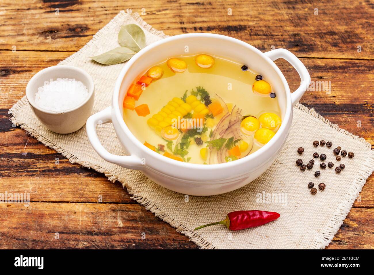 Transparent duck broth with dumplings and vegetables. Traditional ...