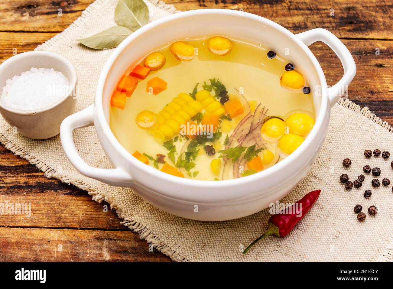 Transparent duck broth with dumplings and vegetables. Traditional ...