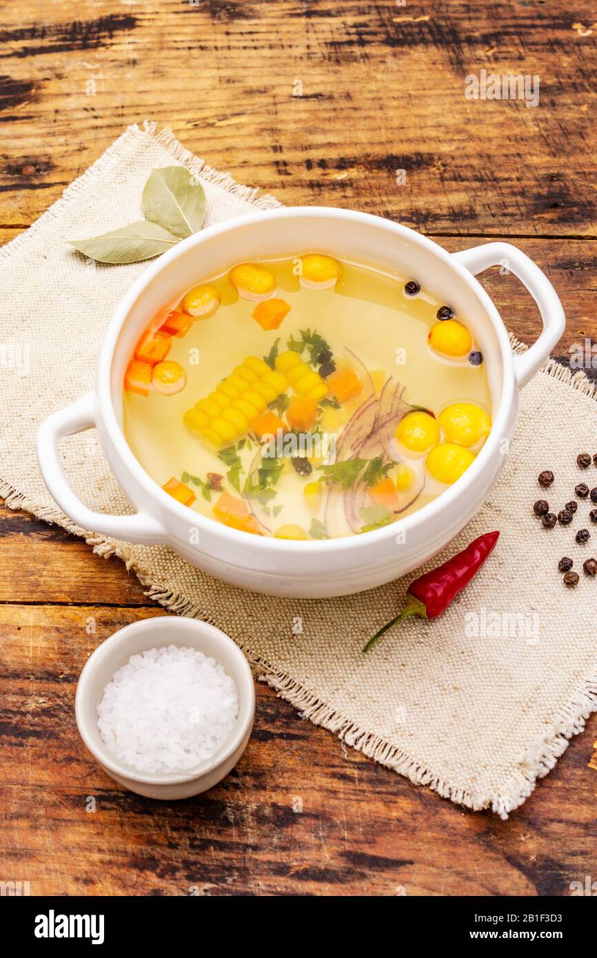 Transparent duck broth with dumplings and vegetables. Traditional ...