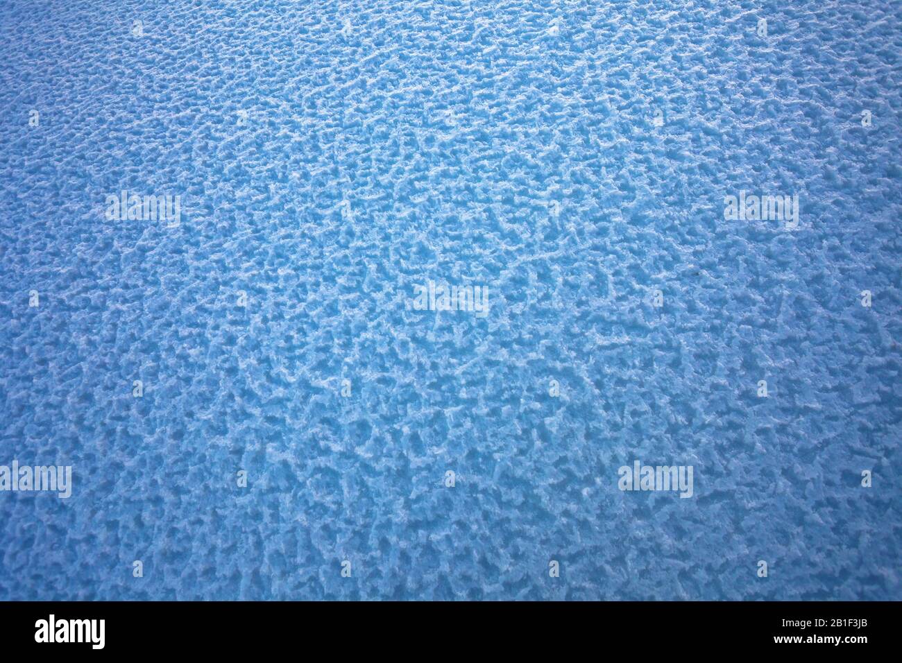Background of frozen snow texture in blue tone field, in the winter ...