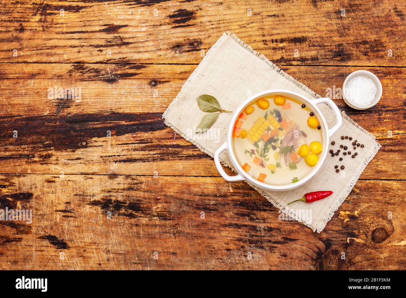 Transparent duck broth with dumplings and vegetables. Traditional ...