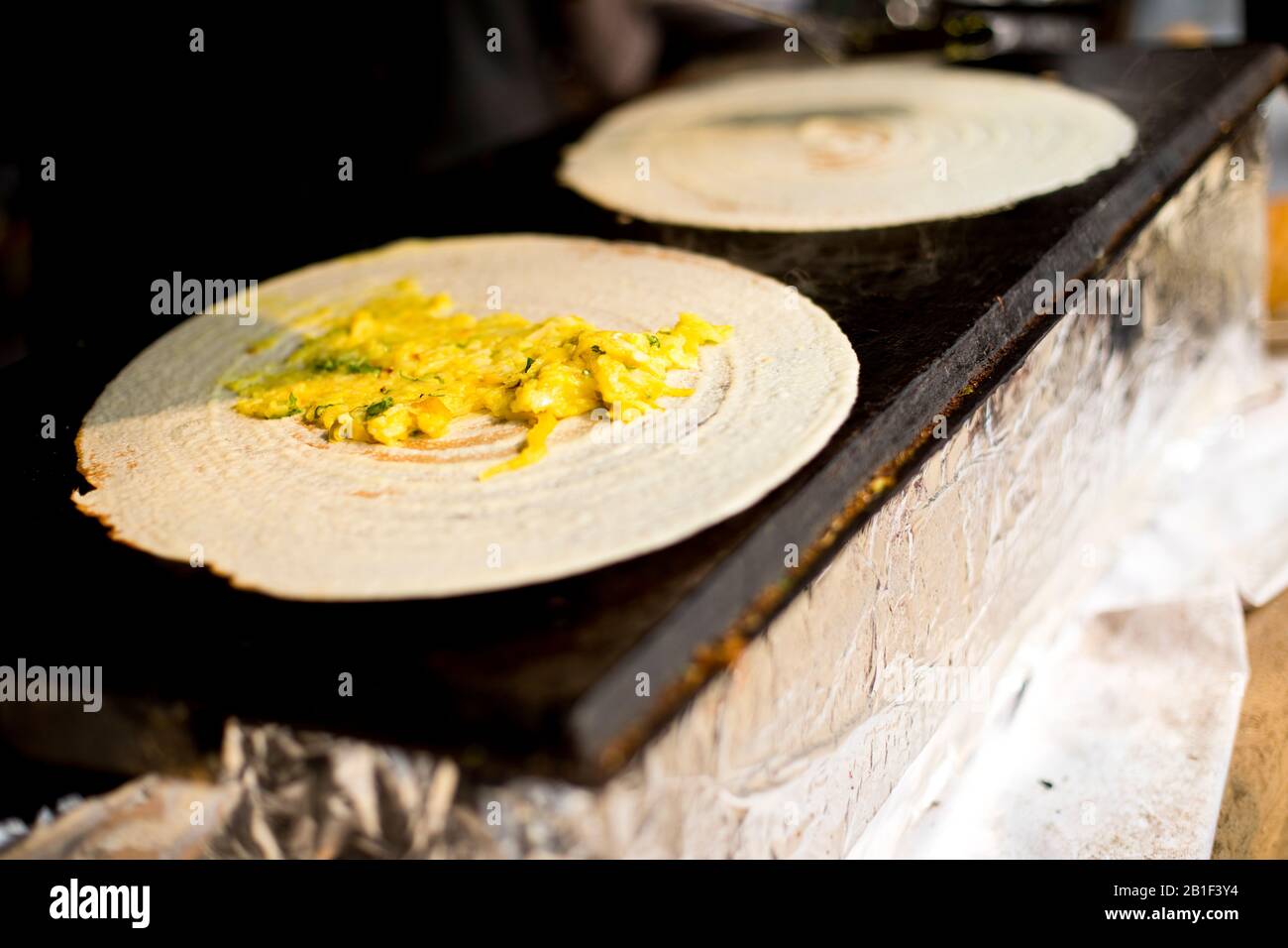Cooking masala dosa at Surajkund Mela food stall Stock Photo - Alamy