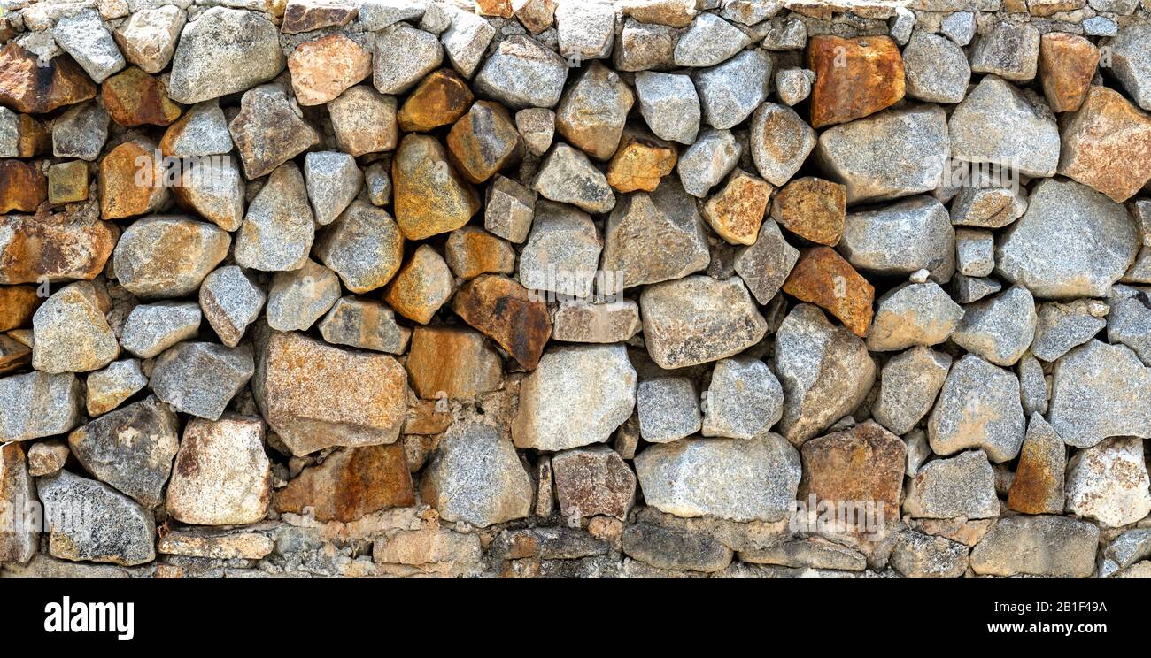 Natural stone masonry wall texture or background Stock Photo - Alamy