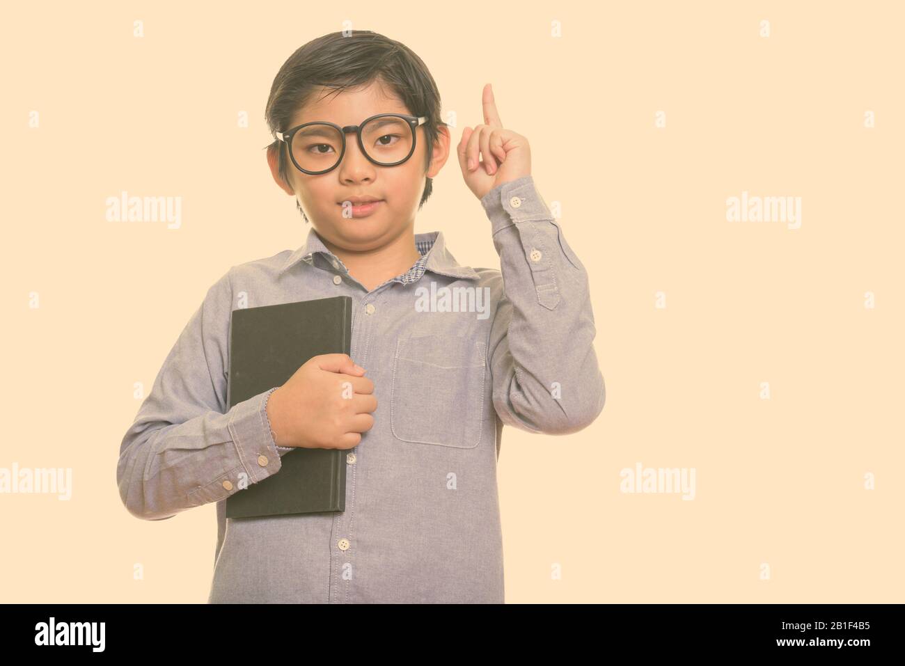 Boy pointing at book hi-res stock photography and images - Alamy