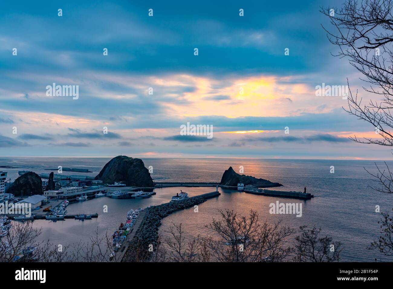 View of Utoro fishing port in springtime with Shiretoko mountain range ...