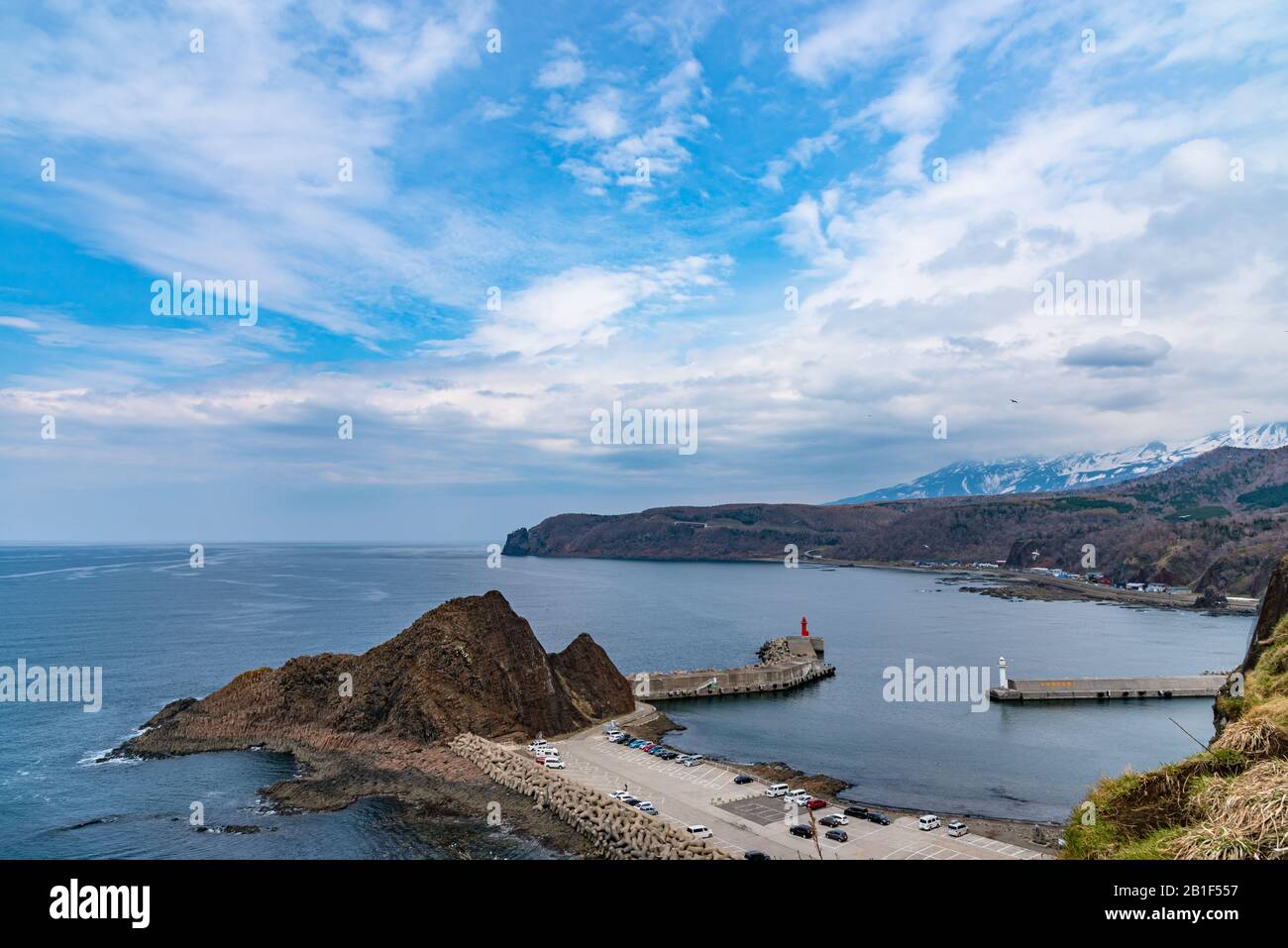 View of Utoro fishing port in springtime with Shiretoko mountain range ...