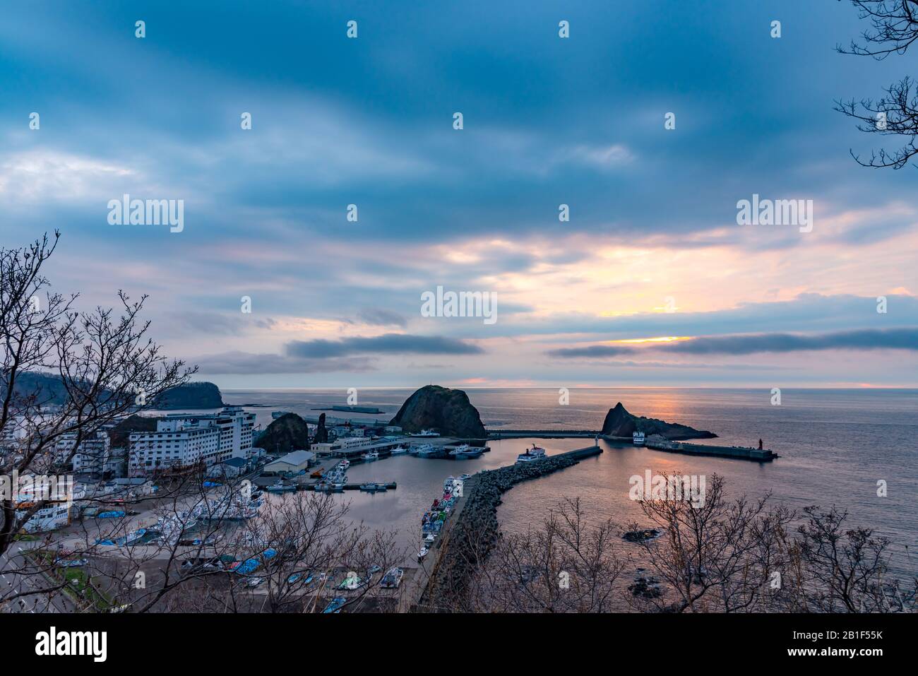 View of Utoro fishing port in springtime with Shiretoko mountain range ...