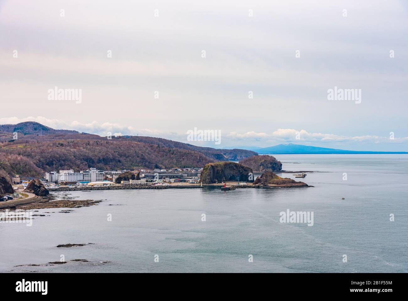 View of Utoro fishing port in springtime with Shiretoko mountain range ...