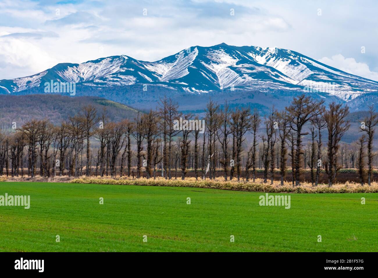 Rural landscapes. Rolling mountain range, farmland field and blue sky ...