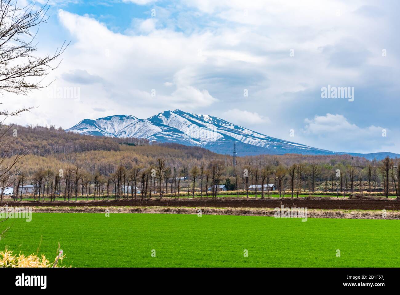 Rural landscapes. Rolling mountain range, farmland field and blue sky ...