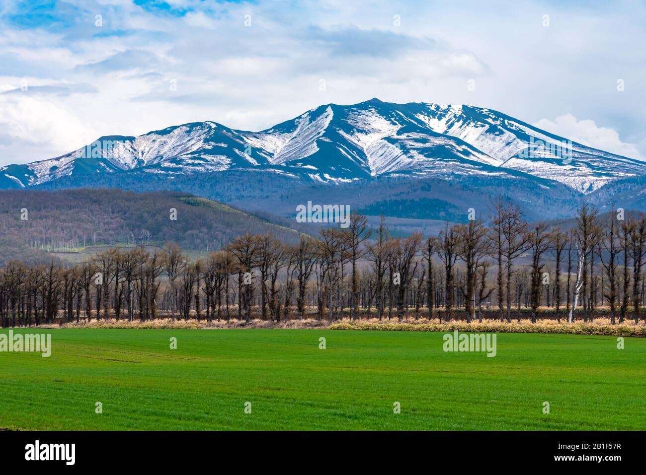 Rural landscapes. Rolling mountain range, farmland field and blue sky ...