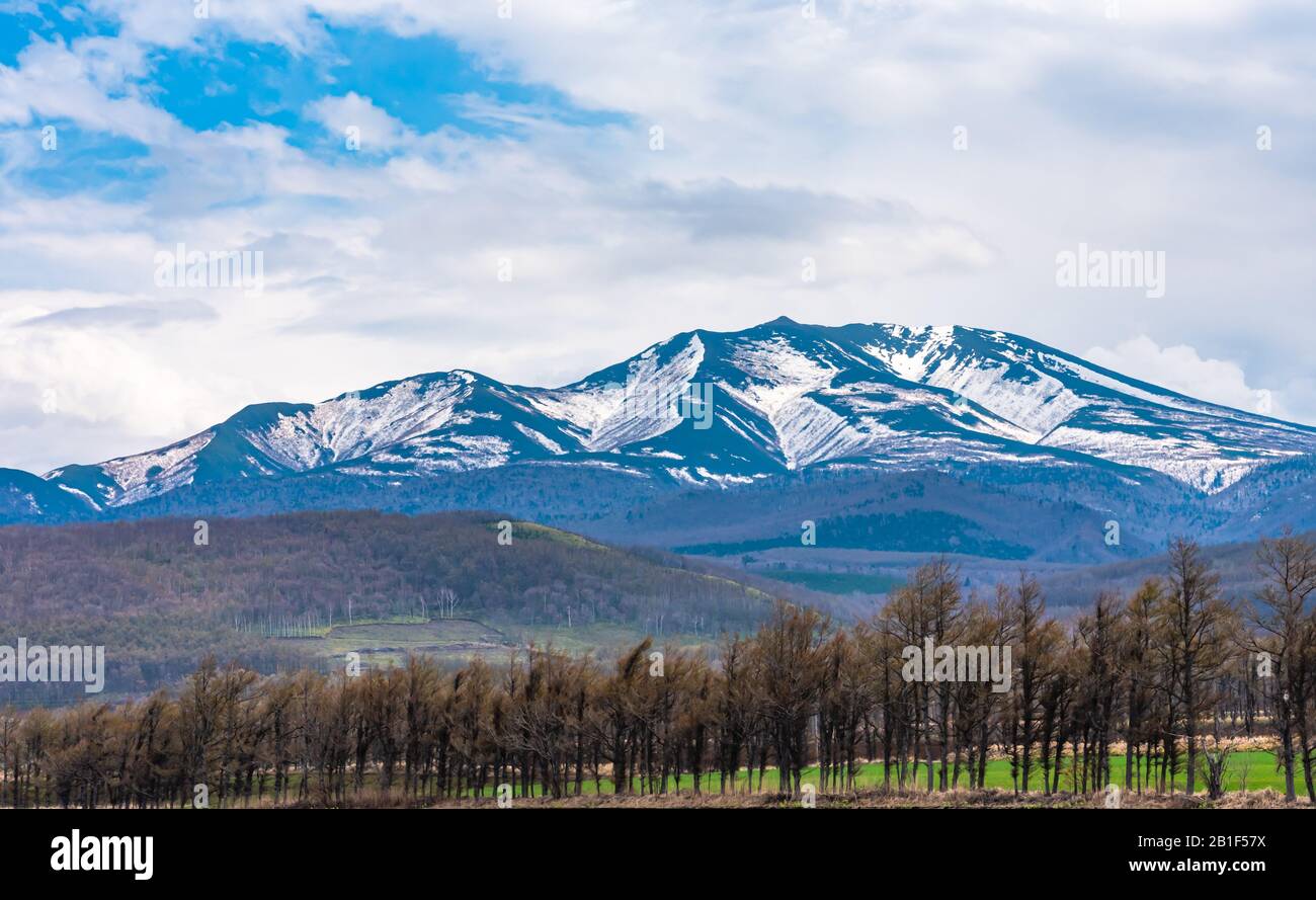Rural landscapes. Rolling mountain range, farmland field and blue sky ...