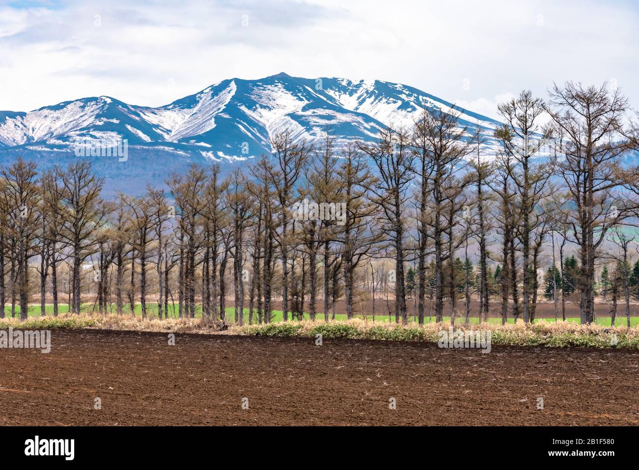 Rural landscapes. Rolling mountain range, farmland field and blue sky ...