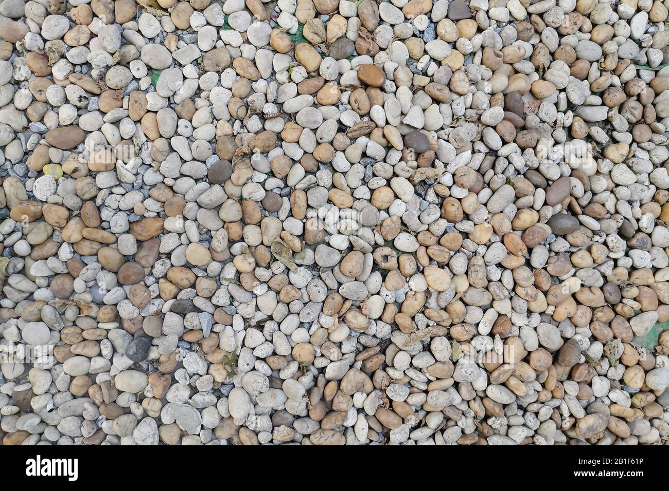 Pebble circle marble rocks pavement texture background Stock Photo - Alamy
