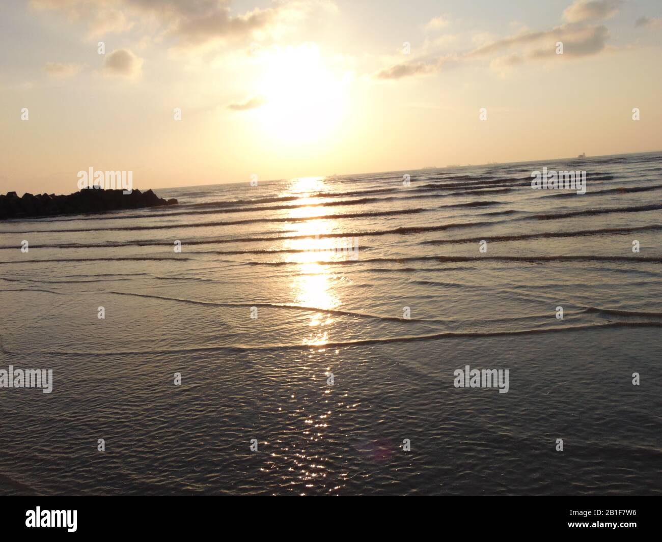 enjoying the sunrise atmosphere on the pasir padi beach Stock Photo - Alamy