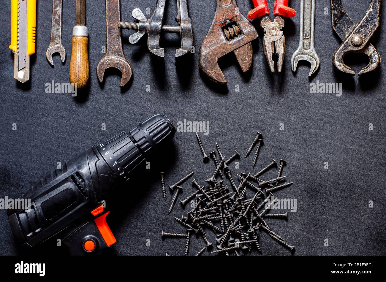 Construction worker tools on a dark background top view Stock Photo - Alamy