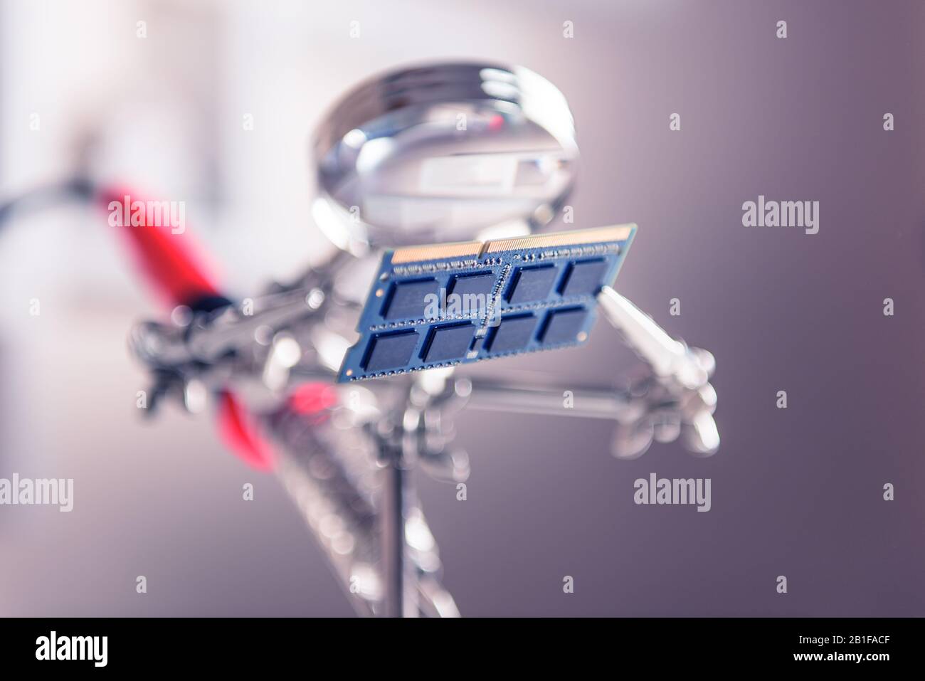 Ram memory module fixed in a holder with clamps, magnifying glass and ...