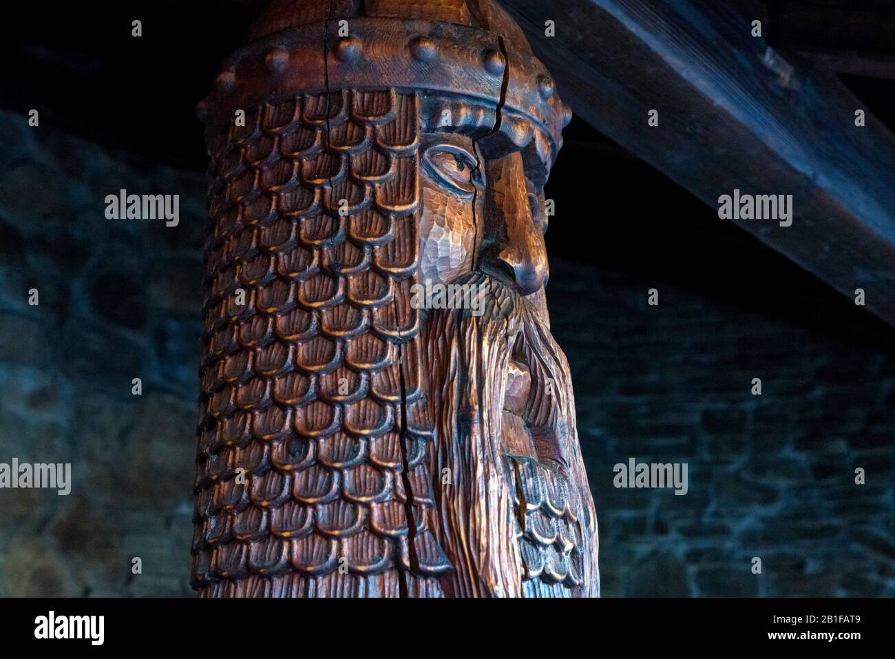Close up wooden pole with carved face of traditional Russian epic ...