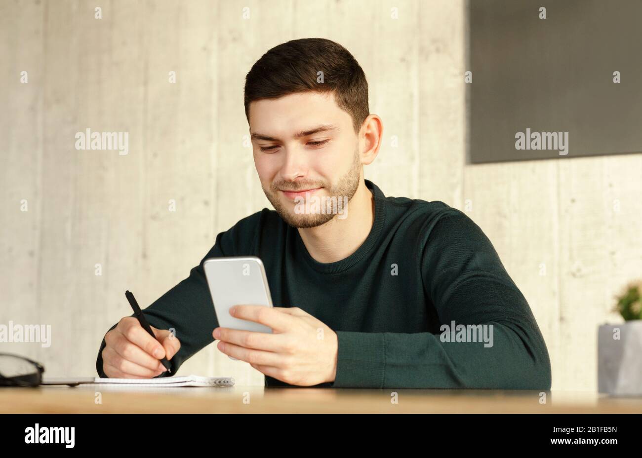 Student Guy Using Smartphone Learning Sitting At Home Stock Photo - Alamy