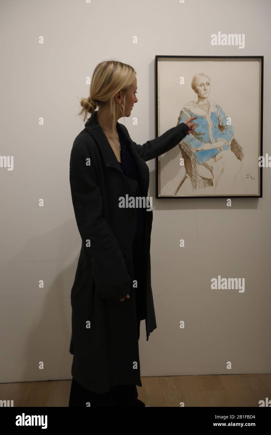 Scarlett Clark as she poses next to her portrait, as part of an ...