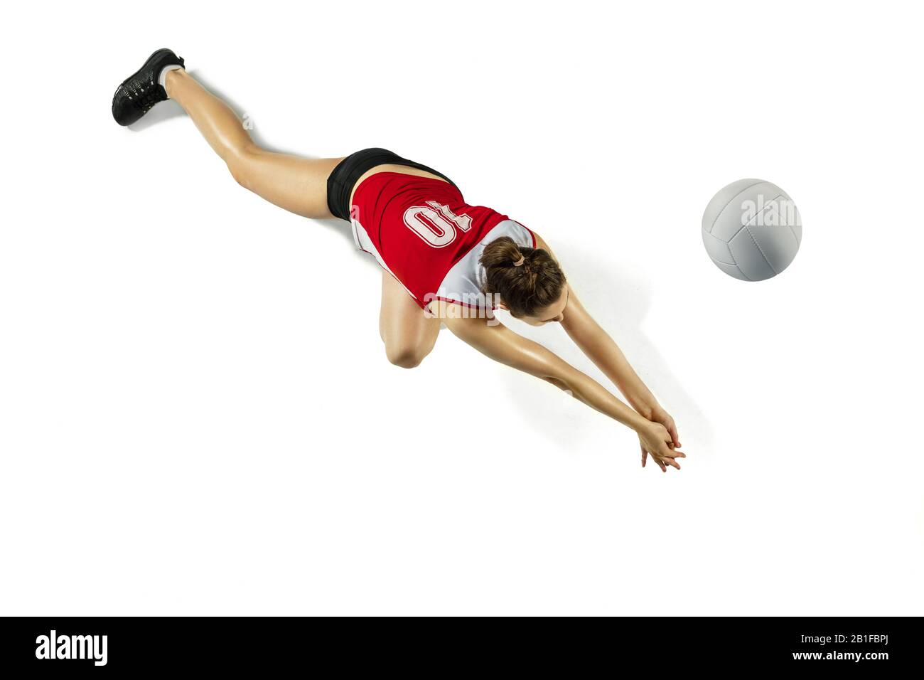 In jump and flight. Young female volleyball player isolated on white ...